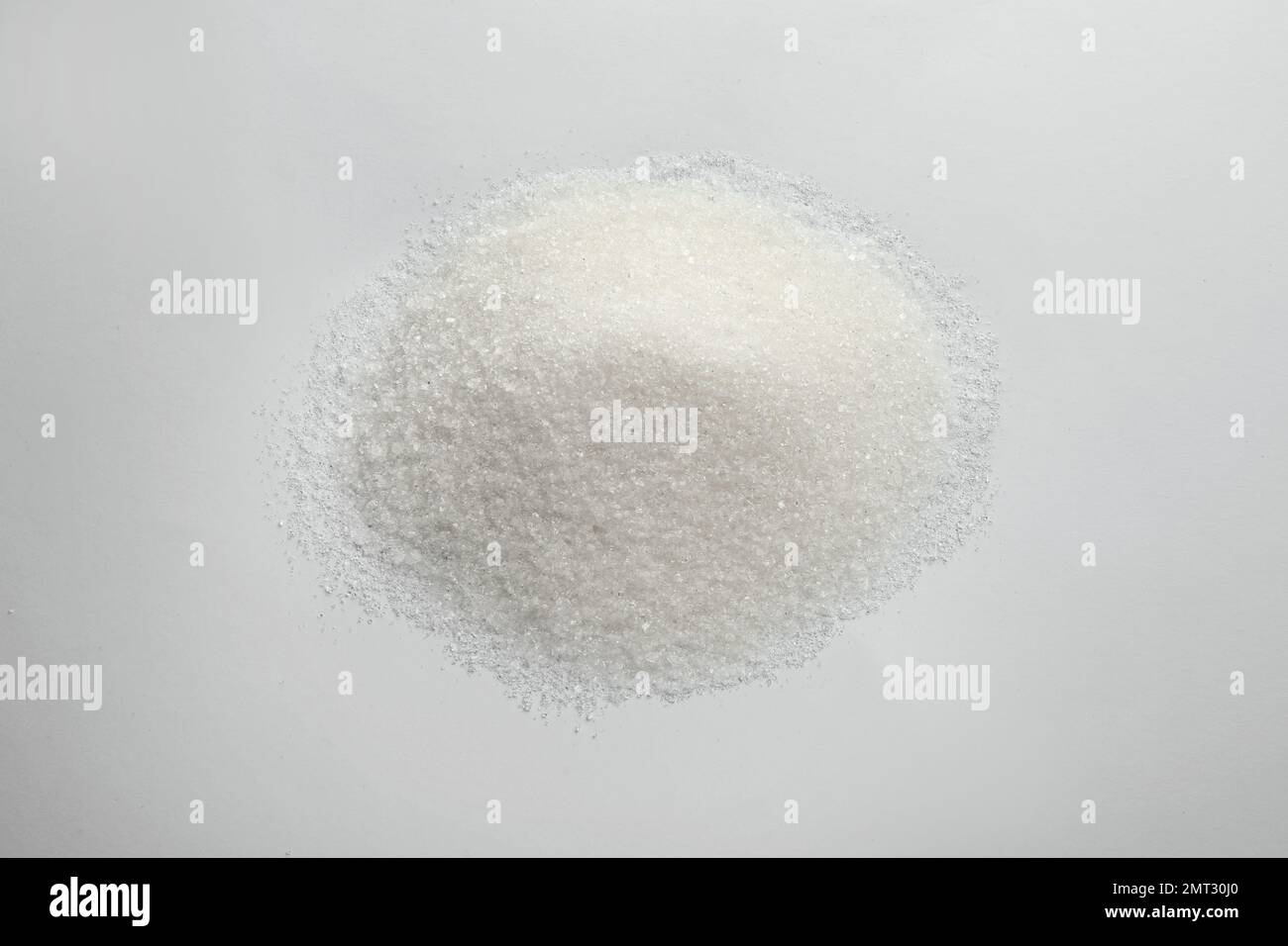 Pile of granulated sugar isolated on white Stock Photo - Alamy