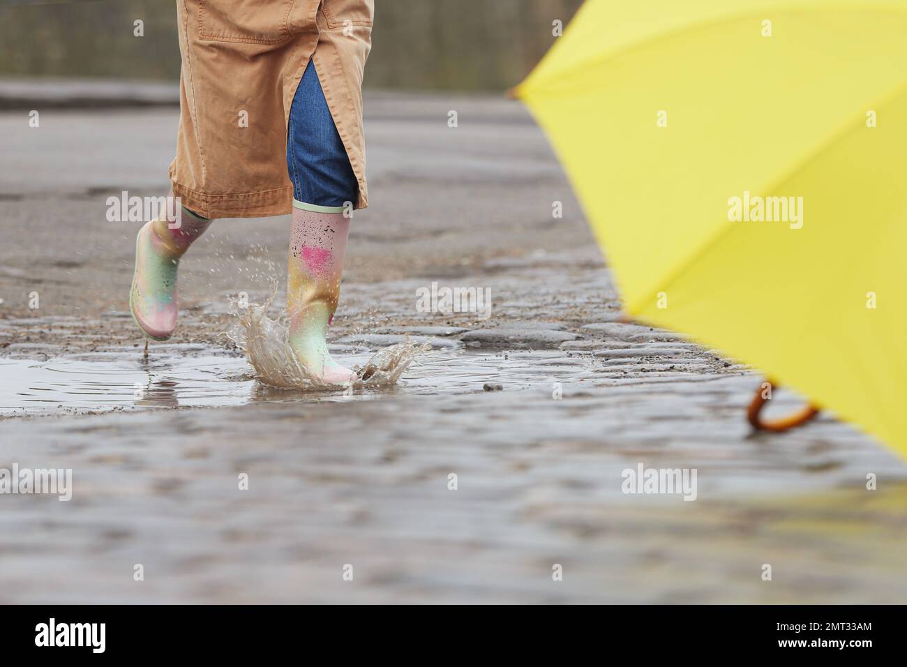 Puddle jumping girl umbrella hi-res stock photography and images - Alamy