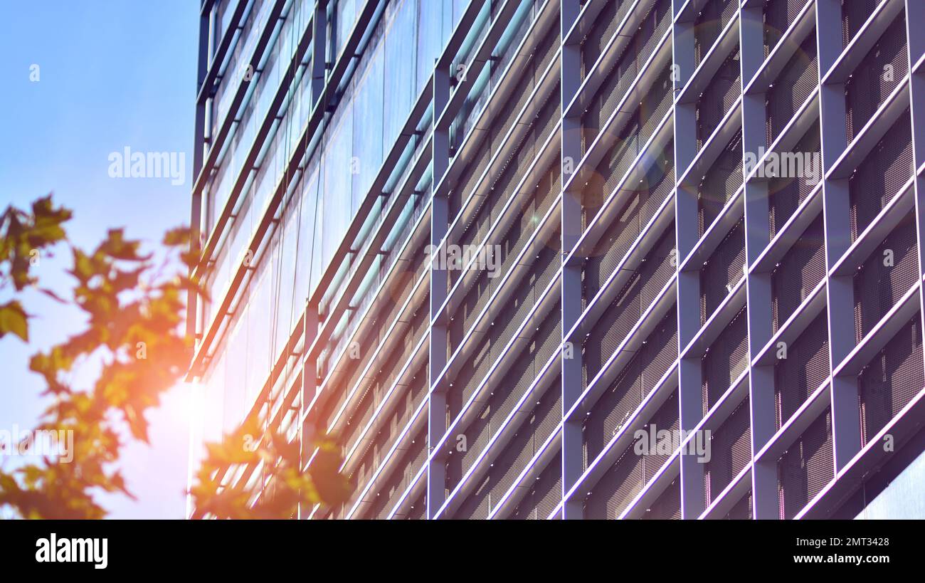Abstract closeup of the glass-clad facade of a modern building covered ...