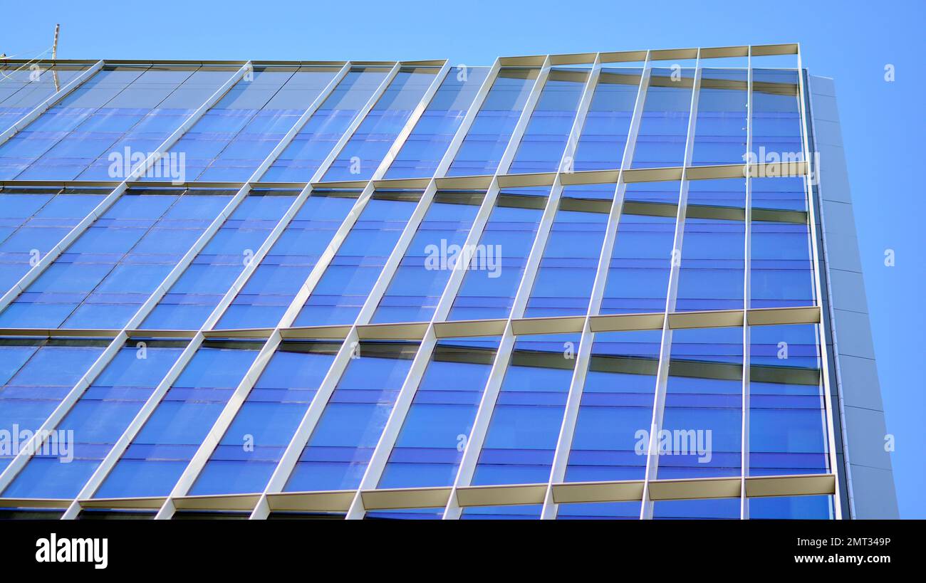 Abstract closeup of the glass-clad facade of a modern building covered ...