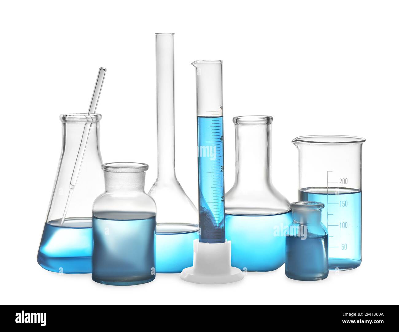 Different laboratory glassware with light blue liquid isolated on white ...