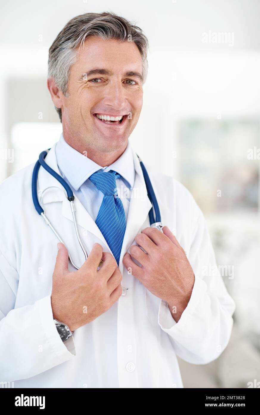 Laughter truly is the best medicine. Portrait of a male doctor standing ...