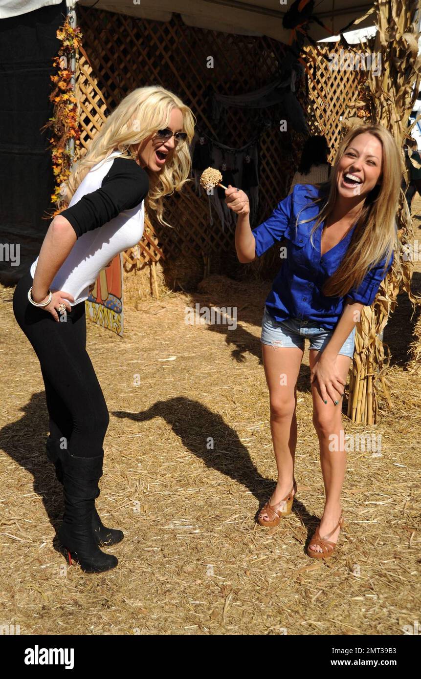 Glamor model Kaki West pretends to eat a candy apple out of actress ...