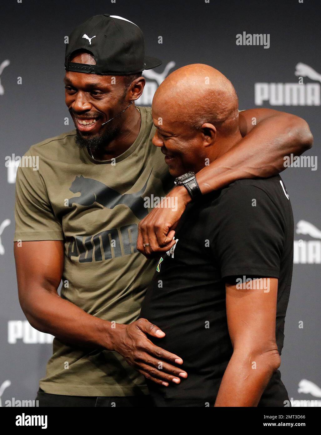 Jamaican athlete Usain Bolt hugs his father Wellesley during a press ...