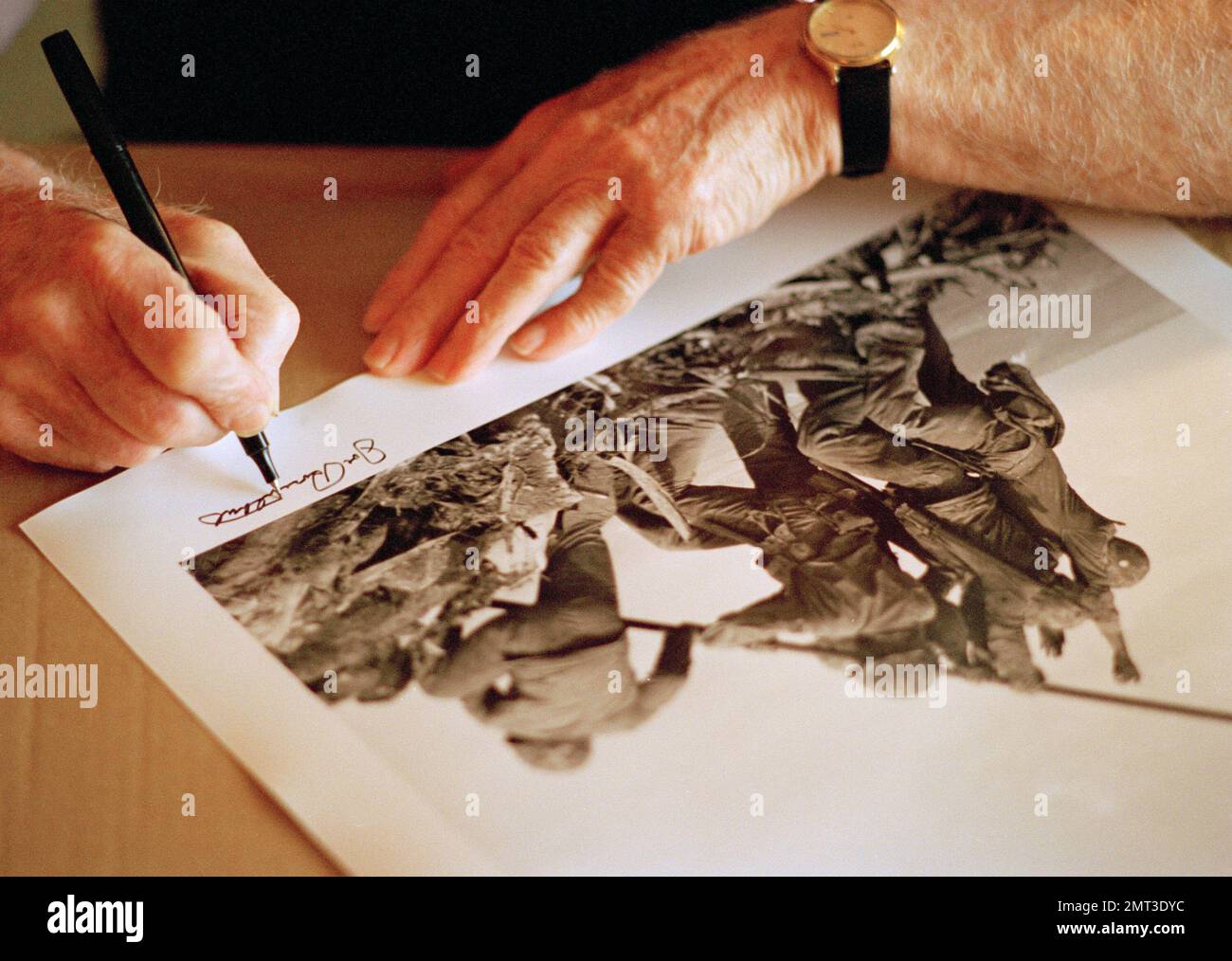Associated Press photographer Joe Rosenthal signs his name in ink on ...