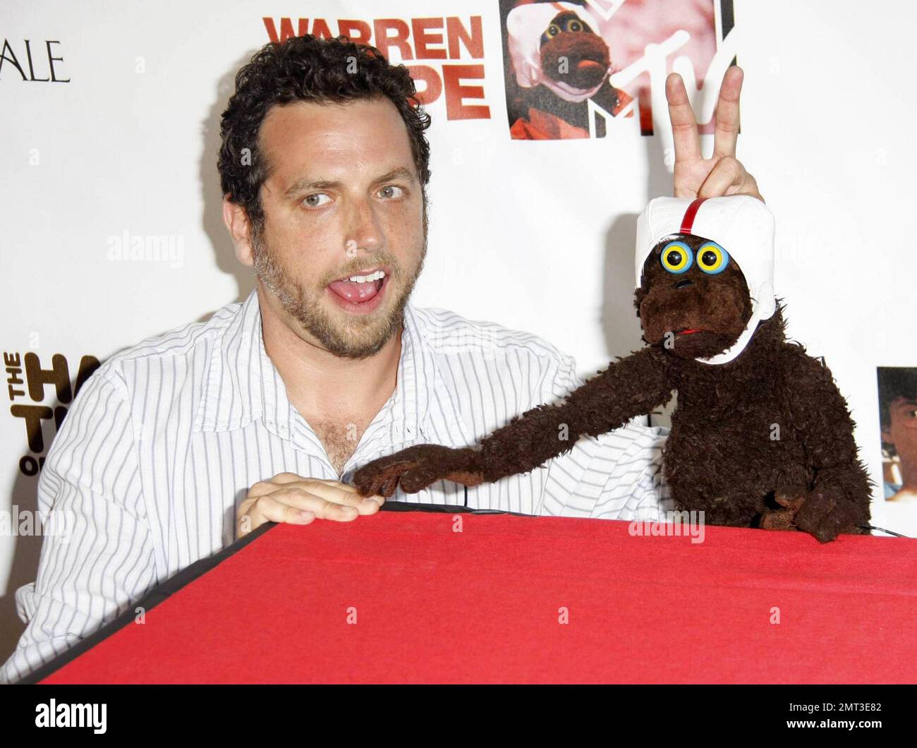 Spencer Chinoy poses with Warren the Ape puppet at the launch party for ...