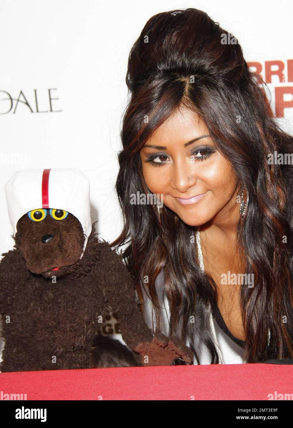 Nicole 'Snooki' Polizzi poses with Warren the Ape puppet as she arrives ...