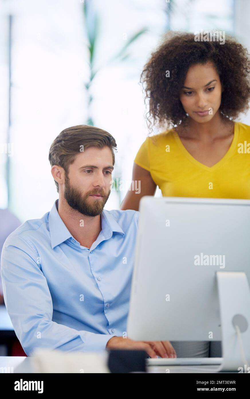 Two heads are better than one. two young colleagues working together at ...