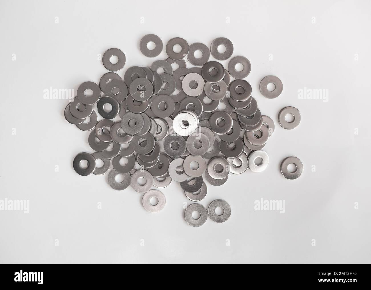 many stainless steel flat washers over light grey background Stock ...