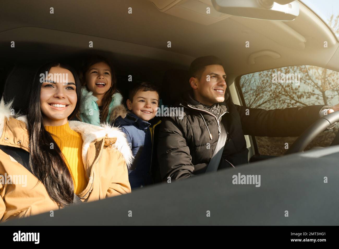 Happy family with little children inside modern car Stock Photo - Alamy