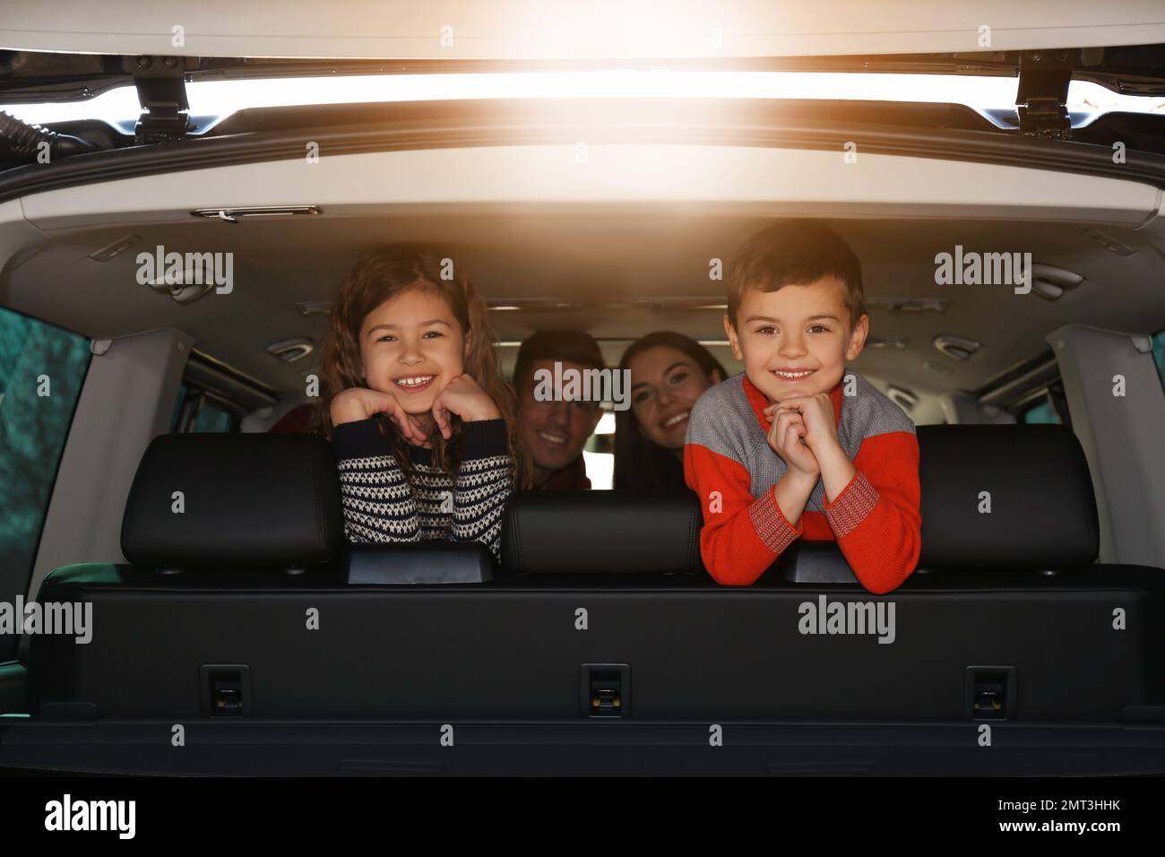 Happy family with little children inside modern car Stock Photo - Alamy