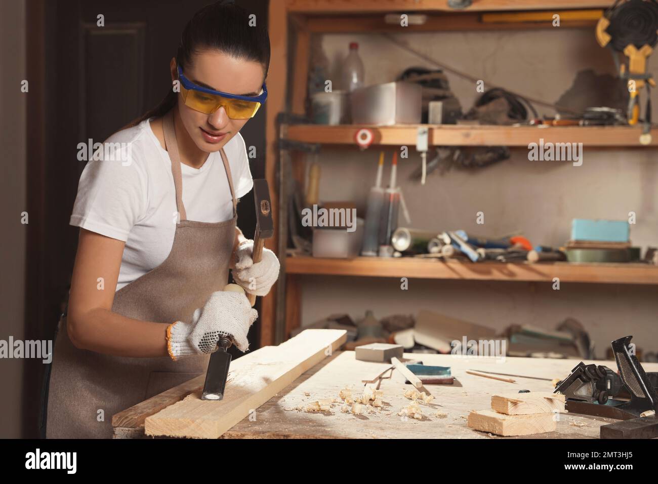 Professional carpenter working with wooden plank in workshop Stock ...