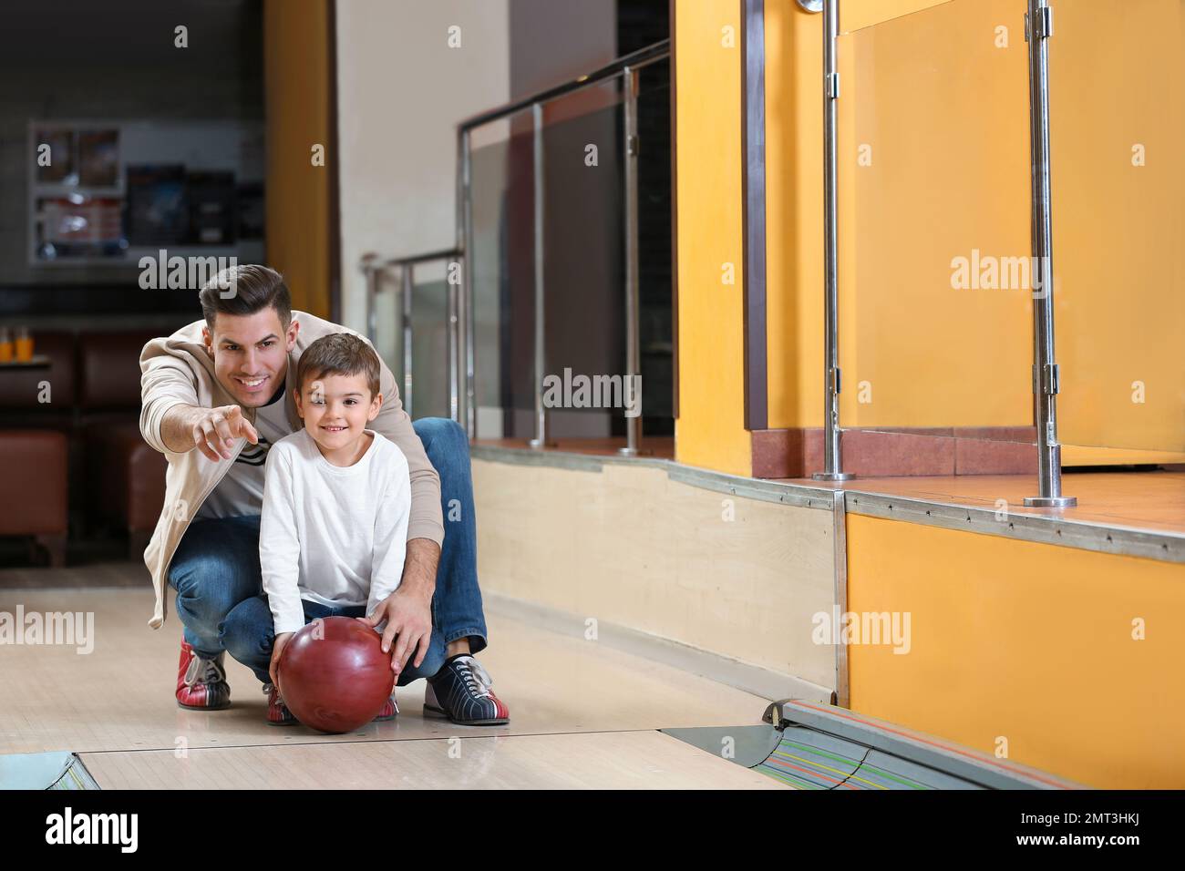 Father and son spending time together in bowling club Stock Photo - Alamy