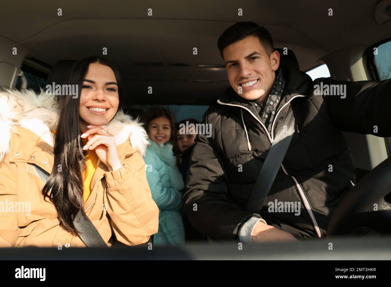 Happy family with little children inside modern car Stock Photo - Alamy