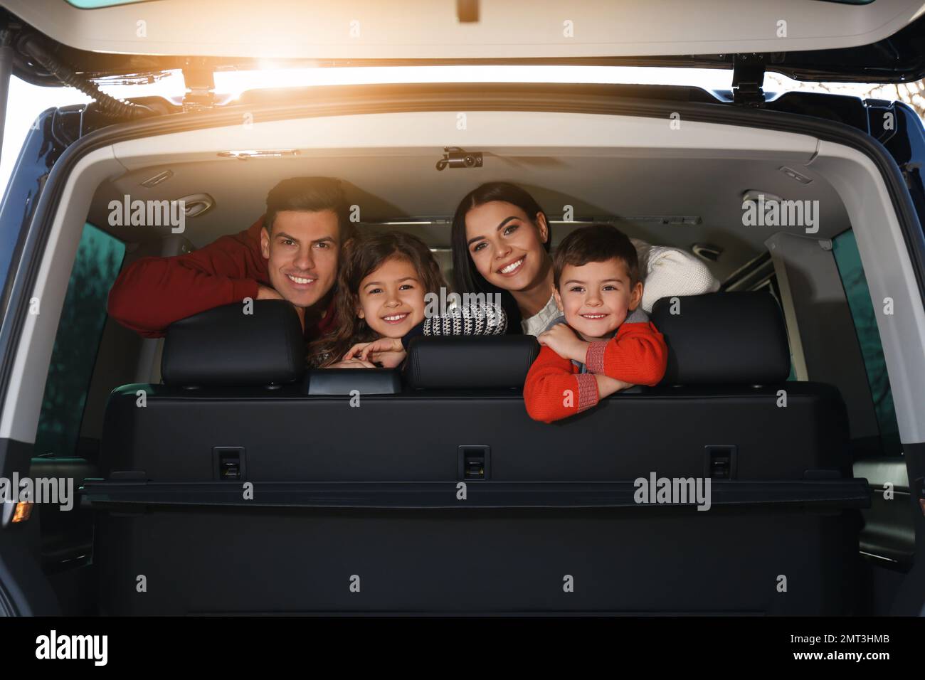 Happy family with little children inside modern car Stock Photo - Alamy