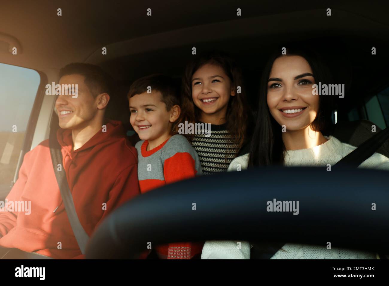 Happy family with little children inside modern car Stock Photo - Alamy