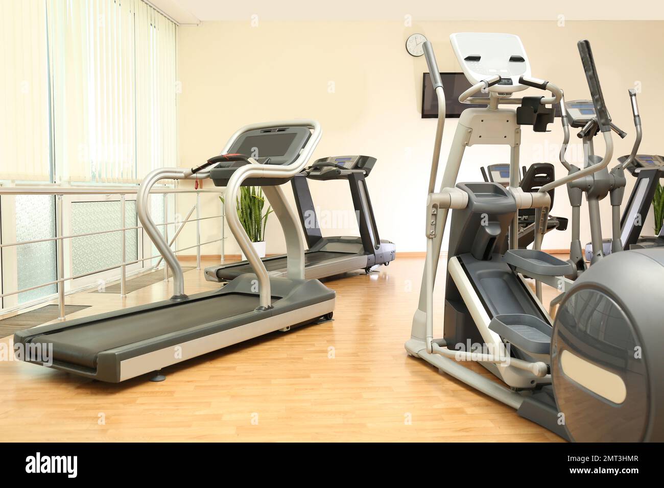 Elliptical trainers and treadmills in gym. Modern sport equipment Stock ...