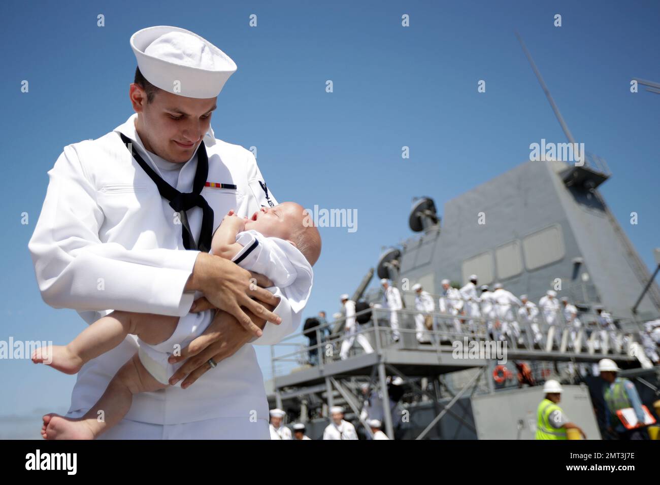 Navy Petty Officer Kyle Parrish holds his four-month-old son Benjamin ...