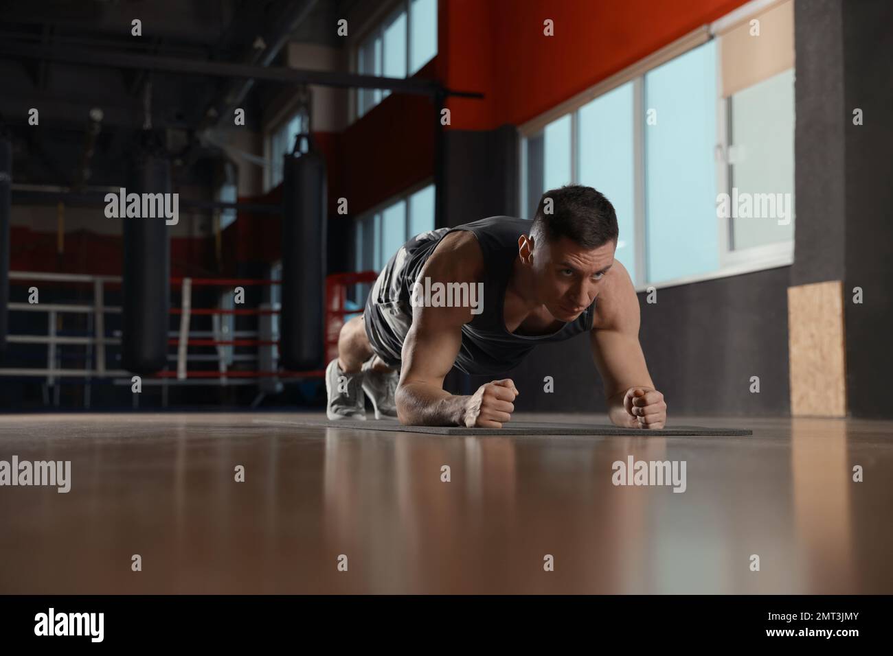 Man doing plank exercise in modern gym Stock Photo - Alamy