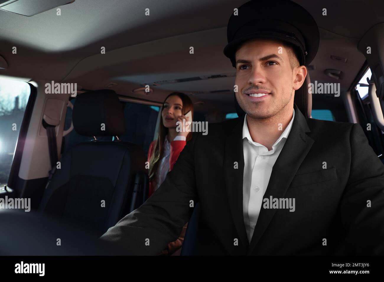 Professional driver and businesswoman in luxury car. Chauffeur service ...