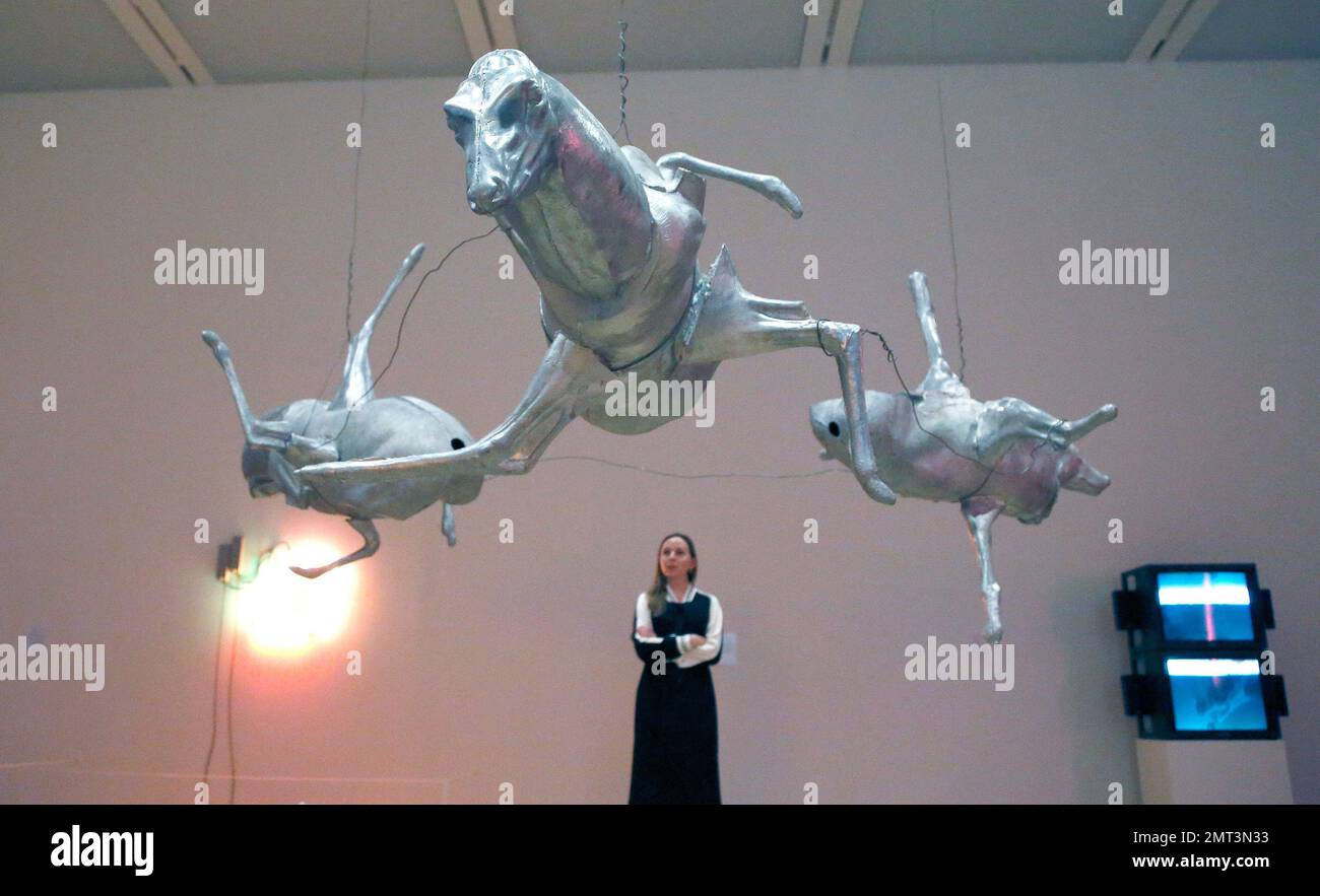 A Tate Modern employee looks at the "Three Large Animals" installation ...