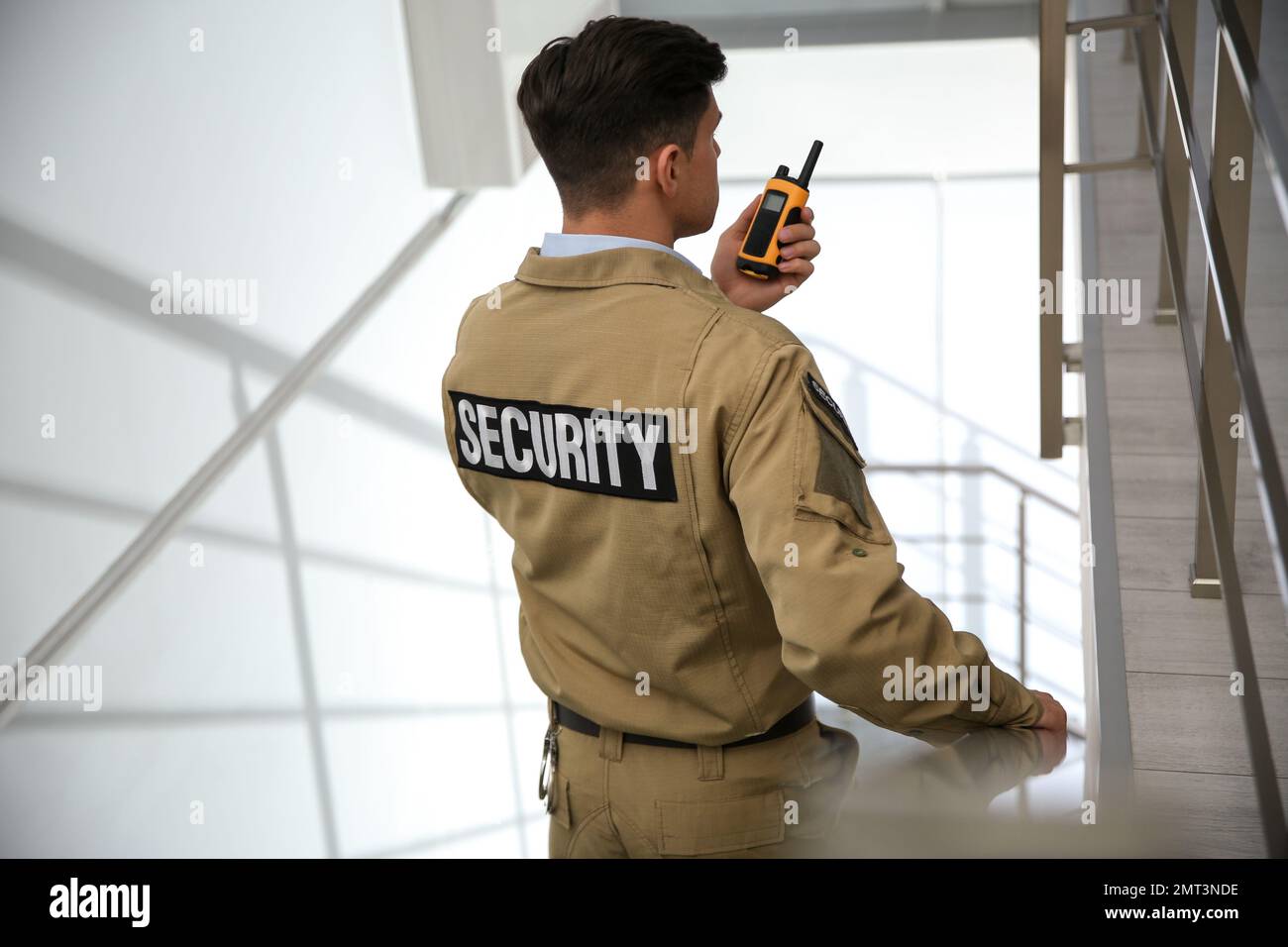 Professional security guard with portable radio set on stairs Stock ...