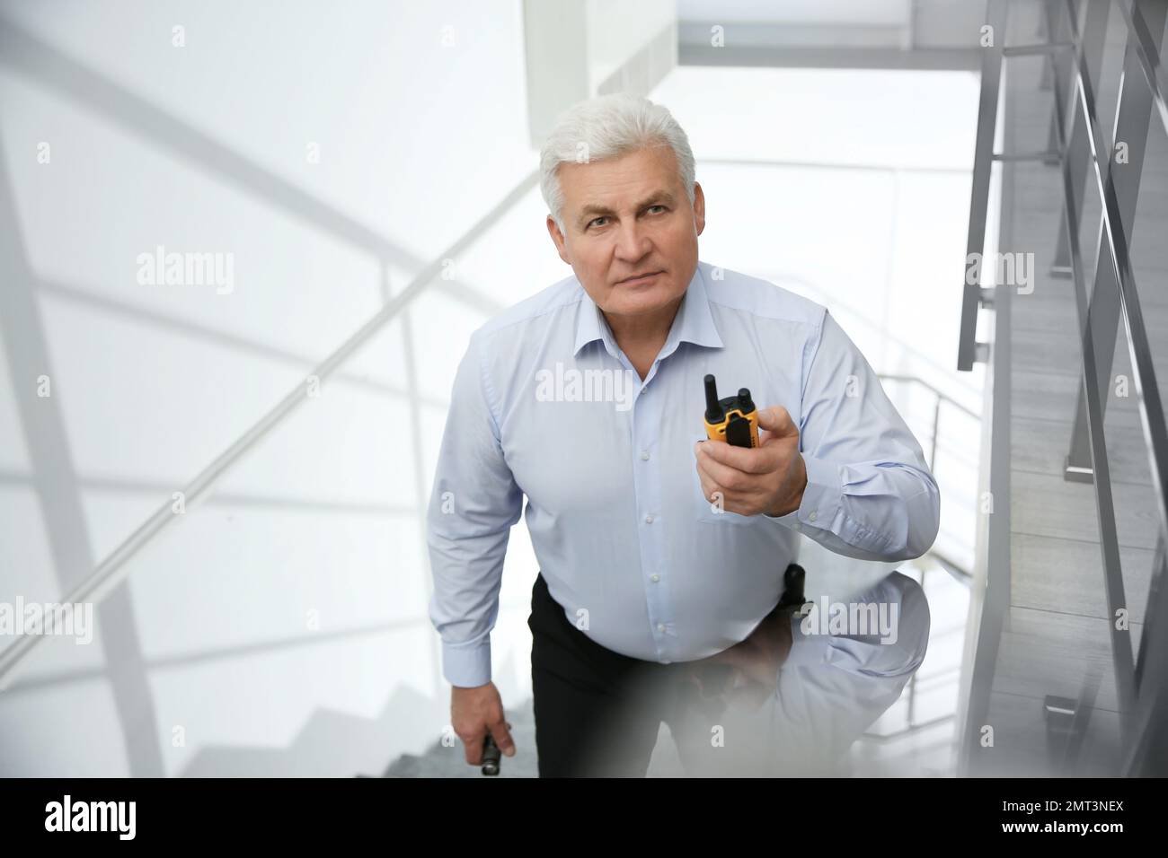 Professional security guard with portable radio set on stairs Stock ...