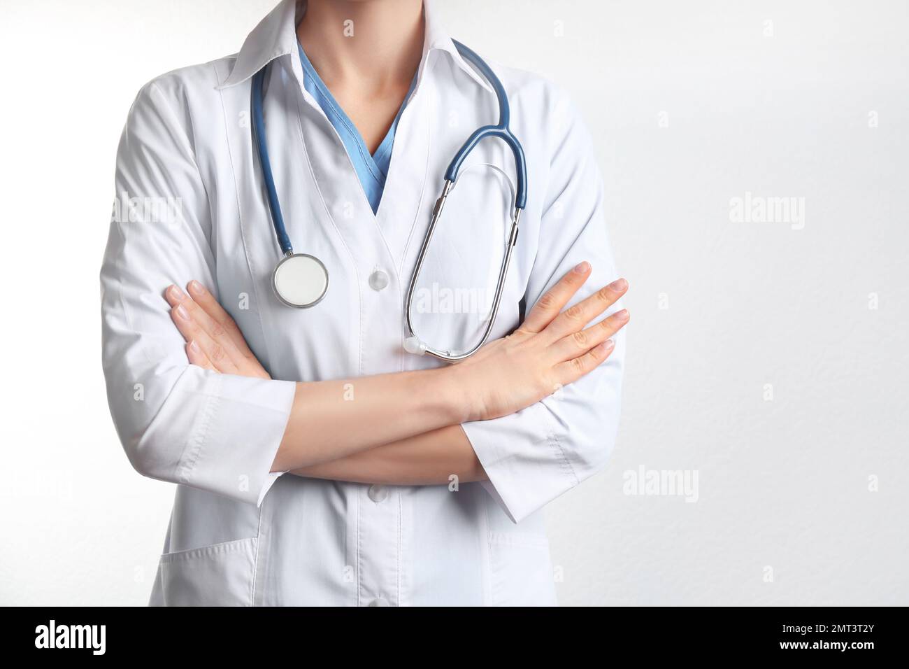 Doctor with stethoscope on white background, closeup. Medical service ...