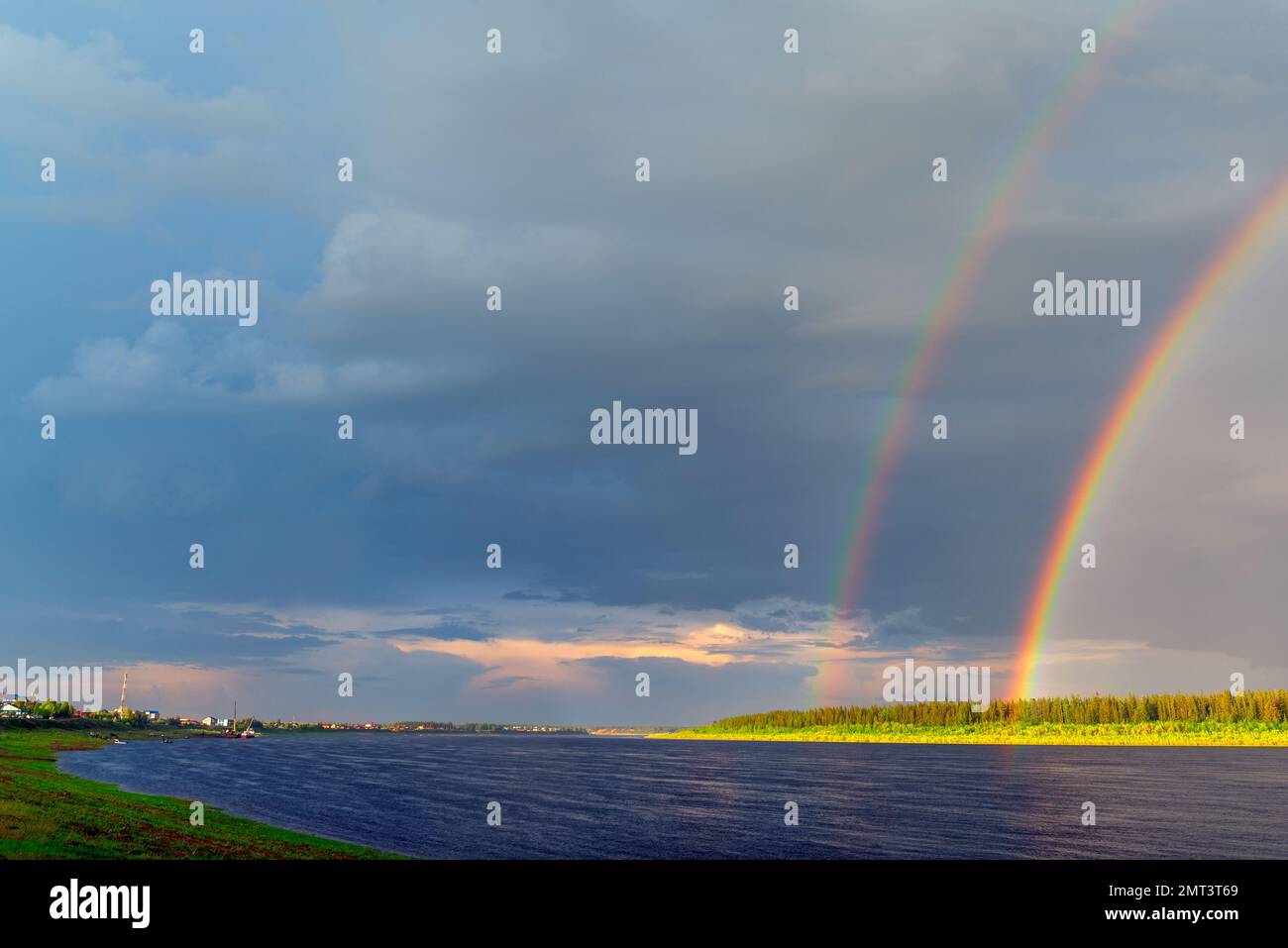 A double rainbow on a rainy day over the Vilyui River against the ...