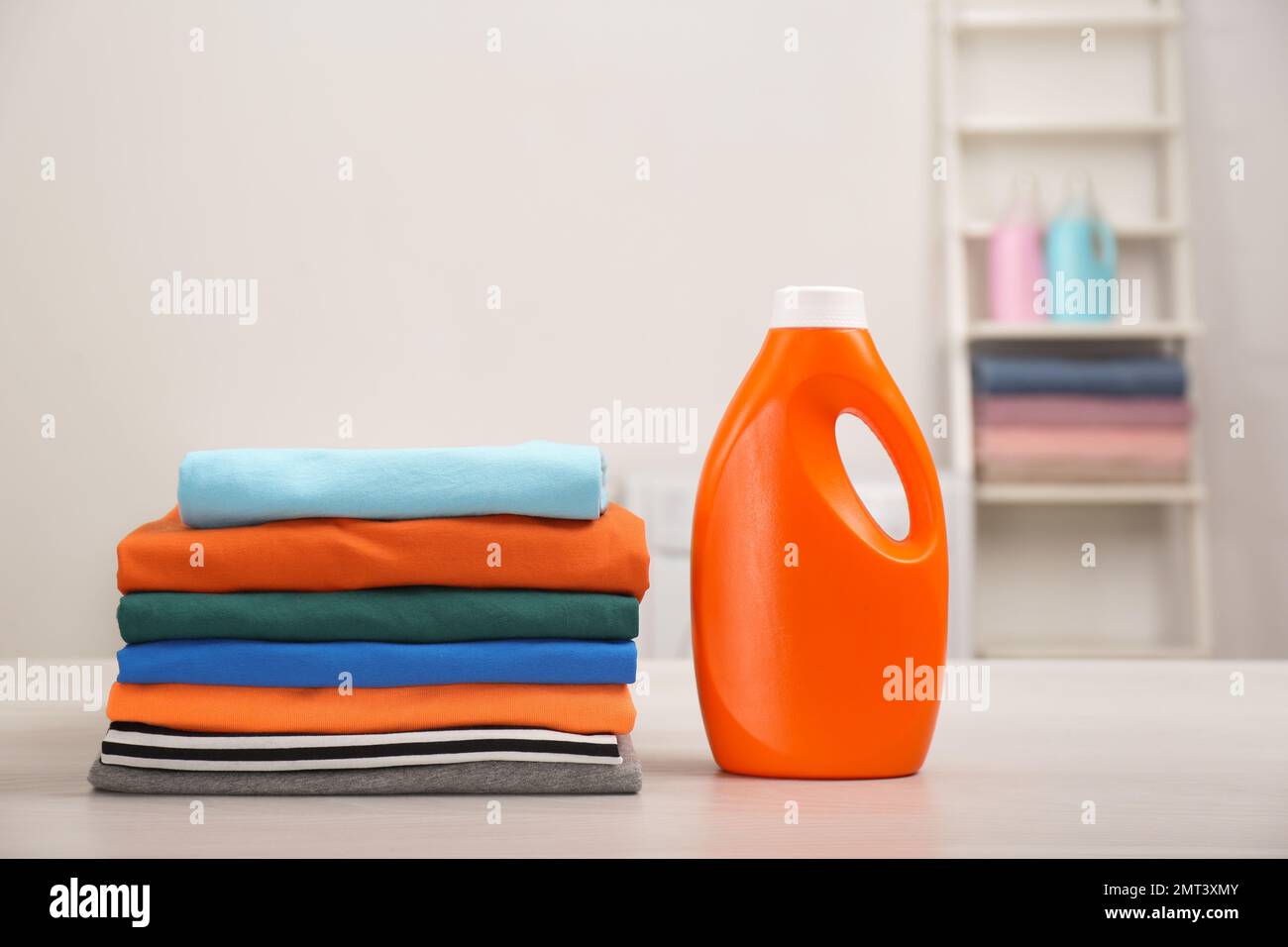 Stack of fresh laundry and detergent on white table in bathroom Stock ...