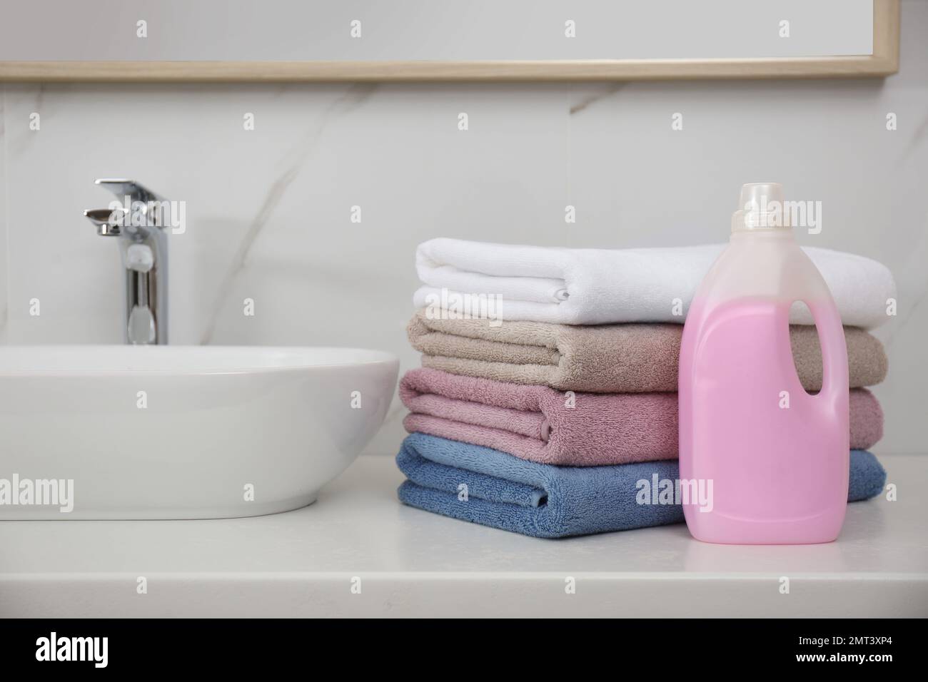 Stack of fresh towels and detergent in laundry room Stock Photo - Alamy