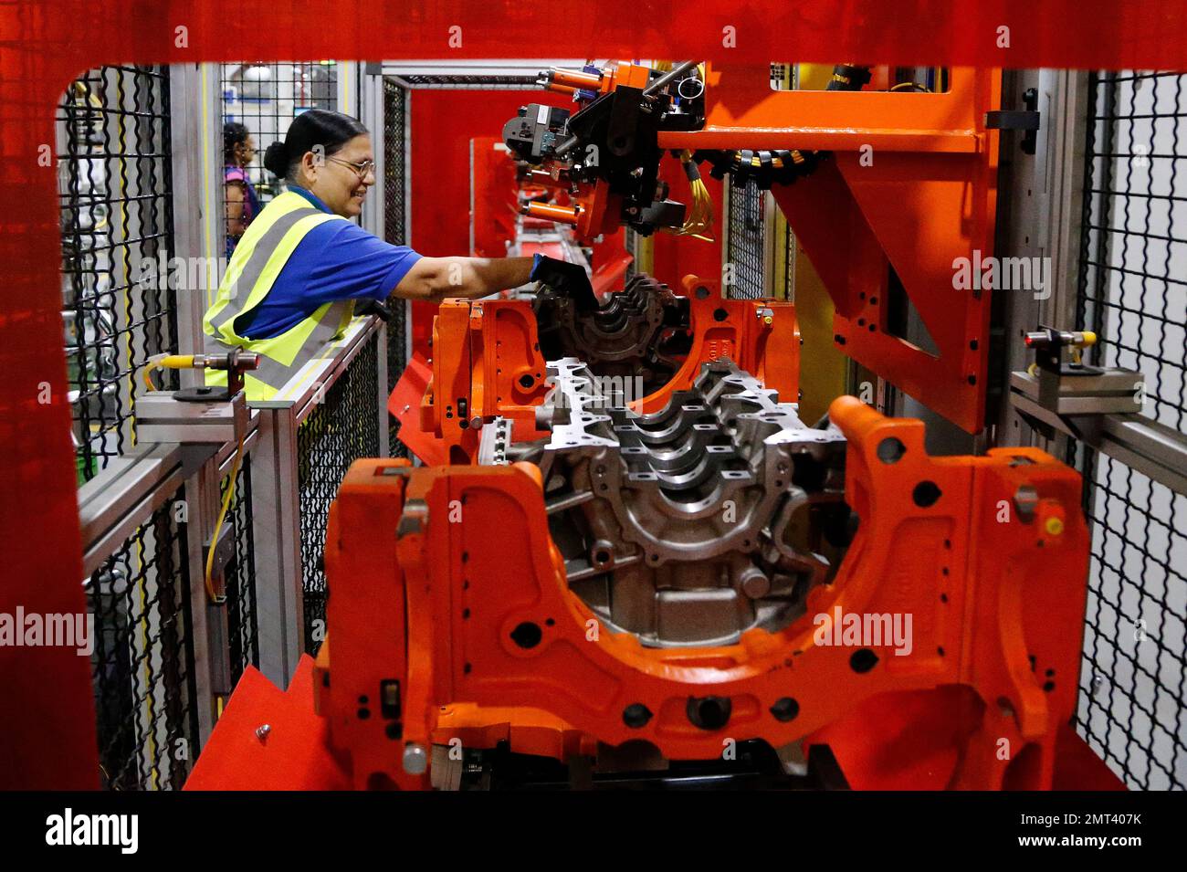 A Ford employee assembles a two liter diesel engine, called panther ...