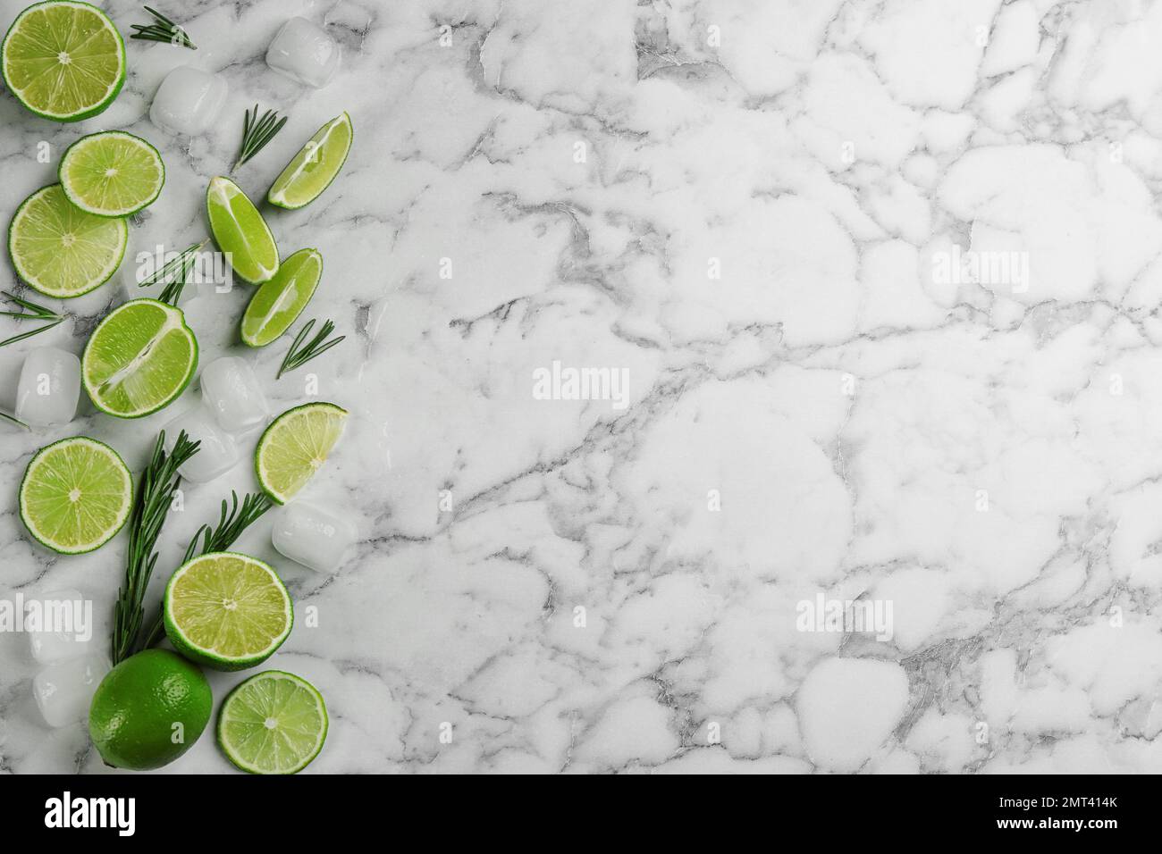 Lemonade layout with juicy lime slices, rosemary and ice cubes on white ...