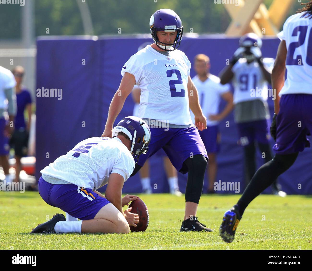 Minnesota Vikings kicker Kai Forbath (2) kicks while Vikings punter ...
