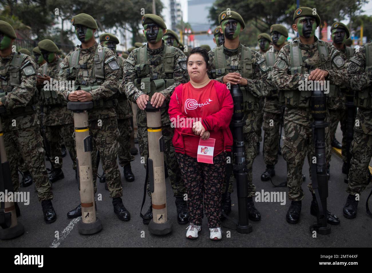 A woman poses for a photo with soldiers before the start of a military ...