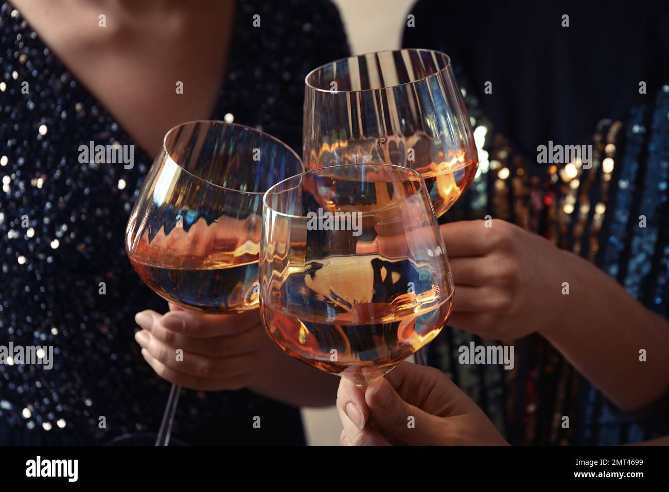 Women clinking glasses with white wine, closeup Stock Photo - Alamy