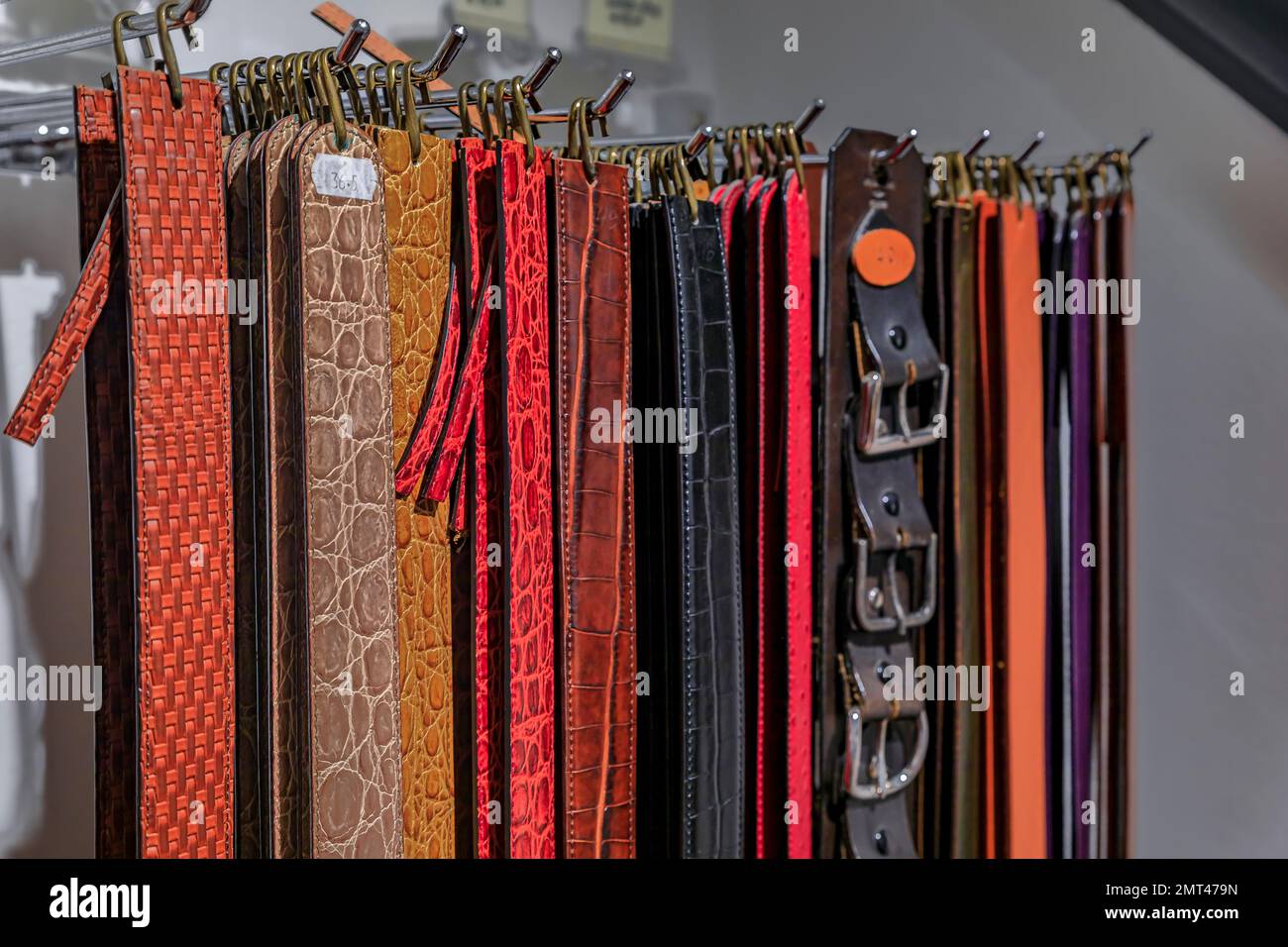 Colorful leather goods, selection of custom made belts on display at an ...