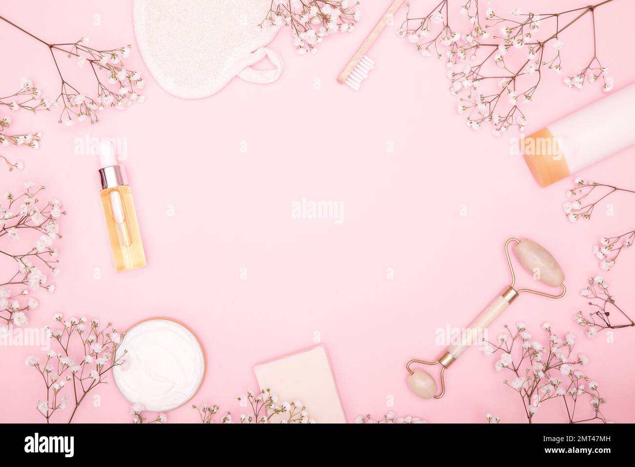 Frame from cosmetic products and hygiene items and dry flowers on a ...