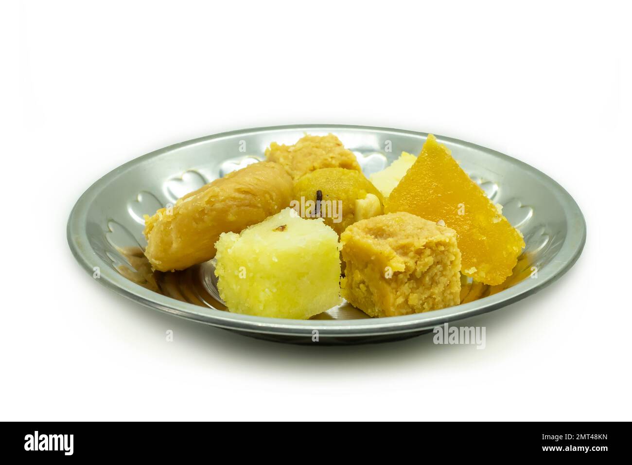 A group of Indian assorted sweets on a plate isolated on the white ...