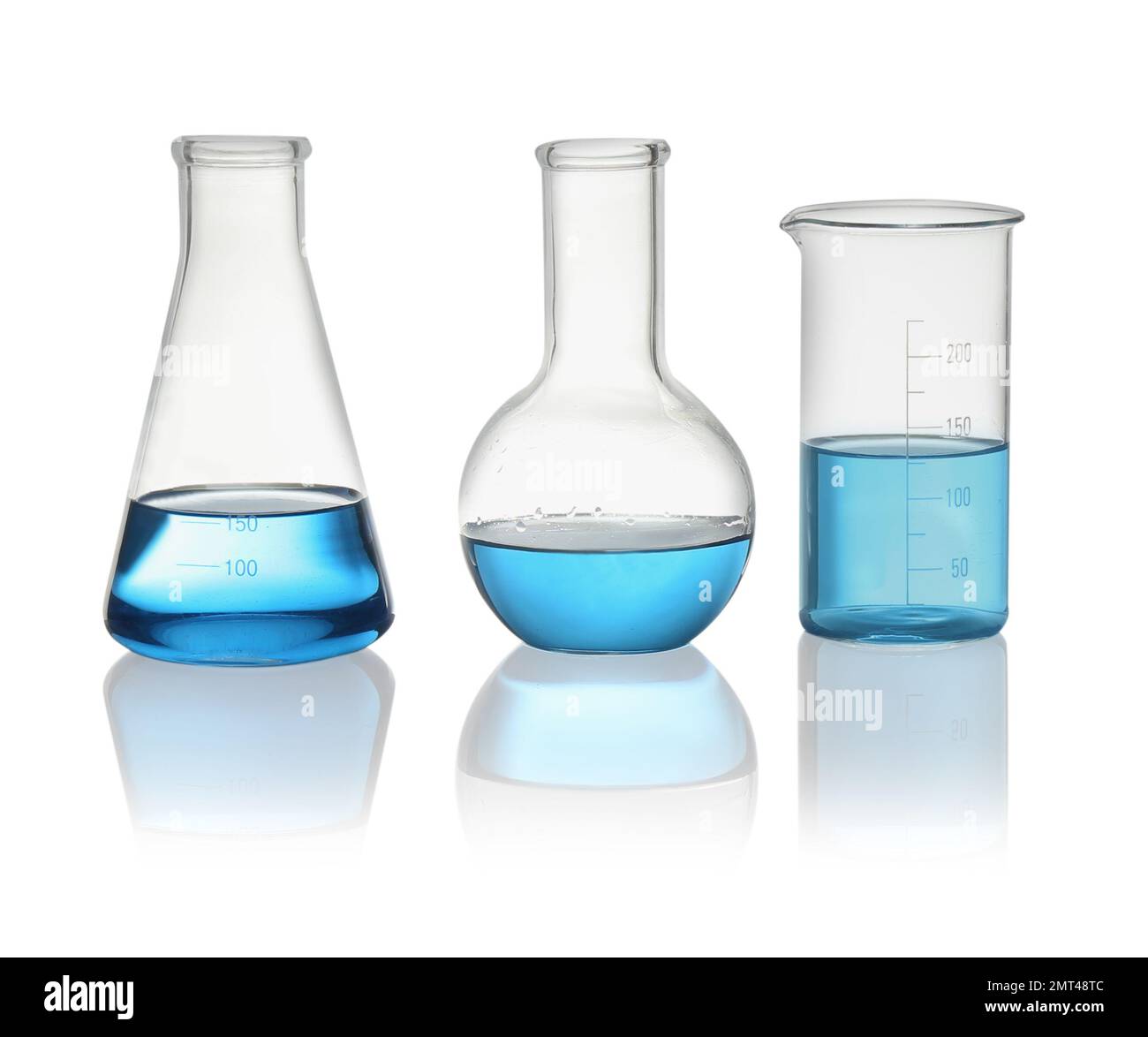 Different laboratory glassware with light blue liquid isolated on white ...