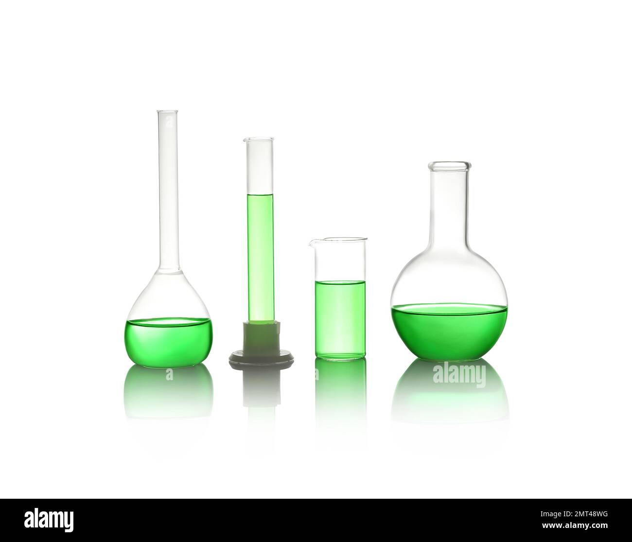 Different laboratory glassware with light green liquid isolated on ...