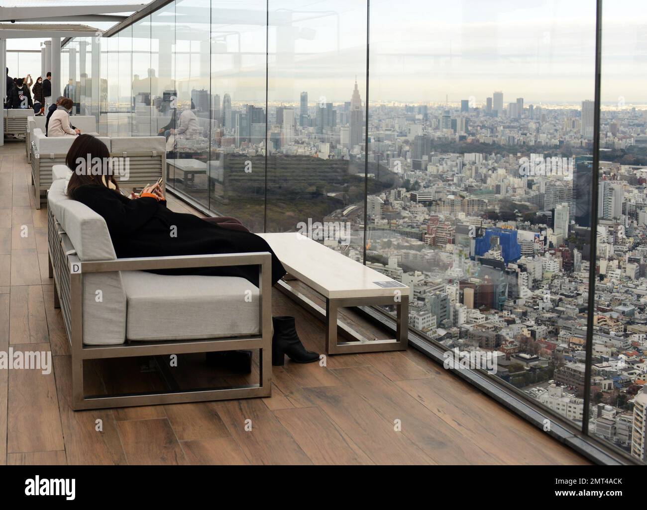 Tourist enjoying the views from the Shibuya Sky rooftop observation ...