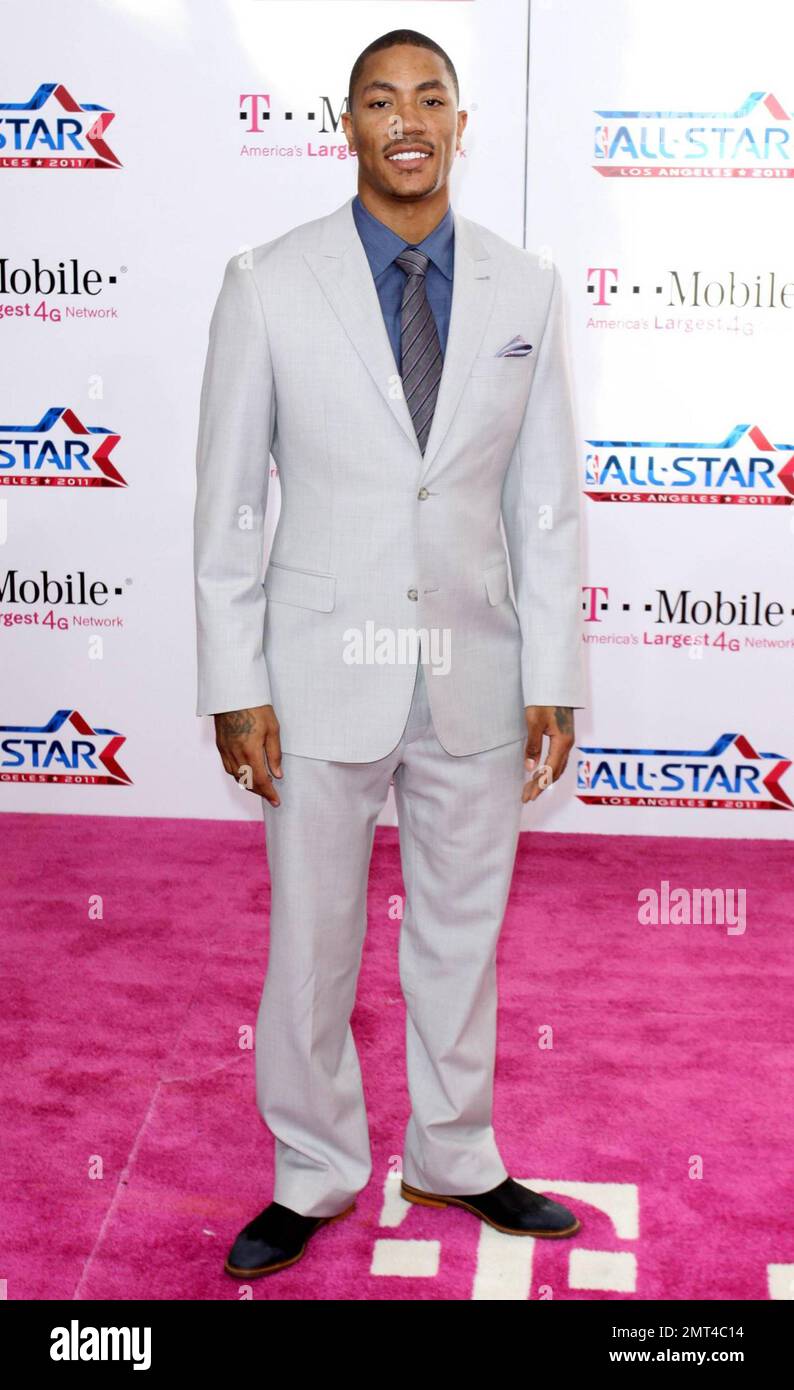 NBA player Derrick Rose of the Chicago Bulls poses for photographers on the pink carpet ahead of ...