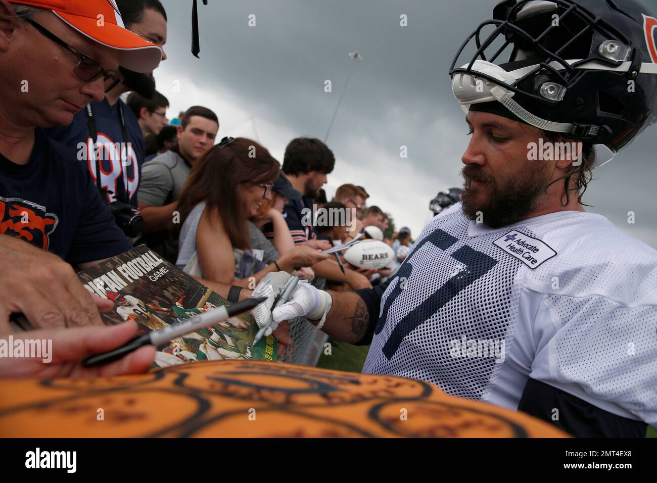 Chicago Bears linebacker Dan Skuta autographs for fans during an NFL ...