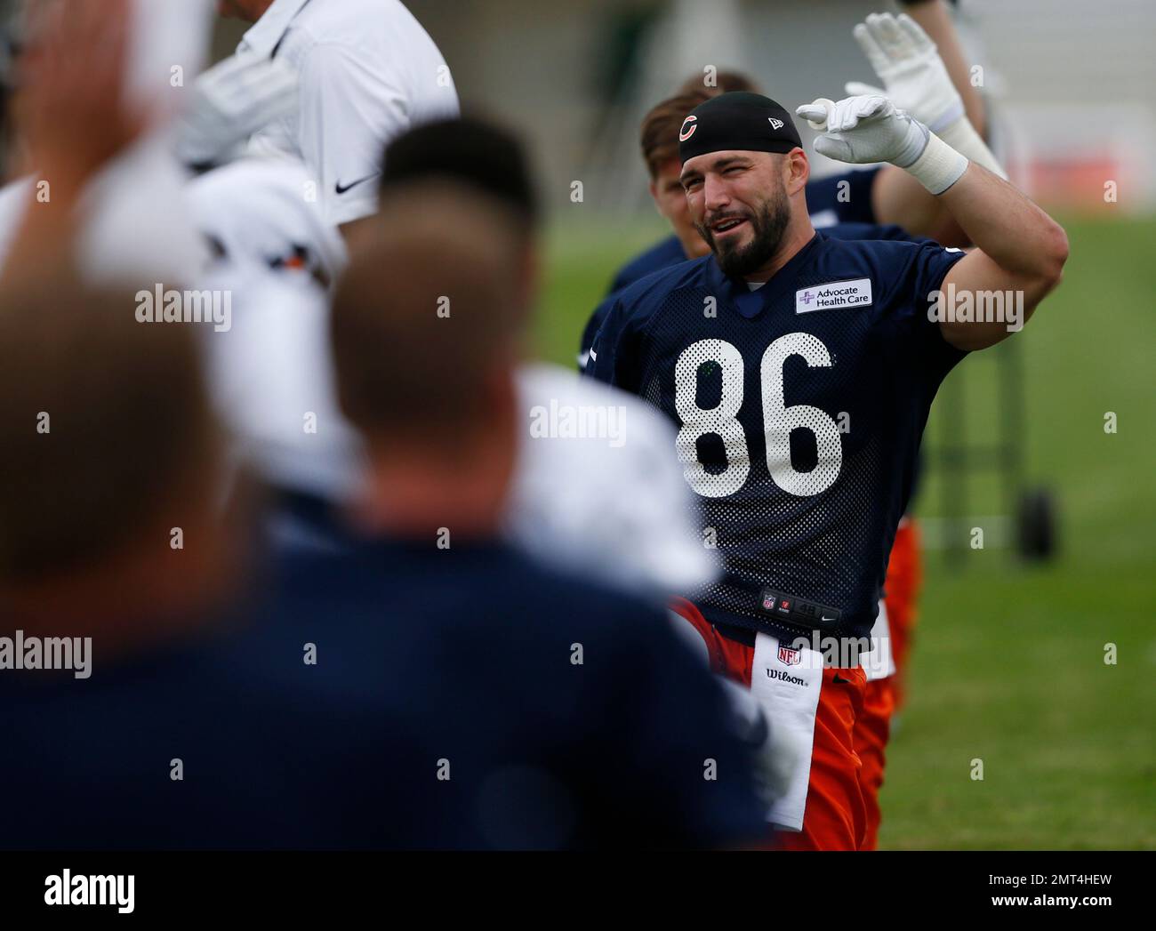 Chicago Bears tight end Zach Miller warms up with teammates stretches ...