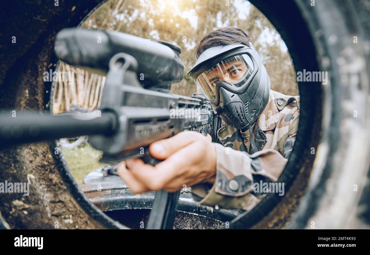Paintball, gun and man with focus, safety uniform and extreme sports ...