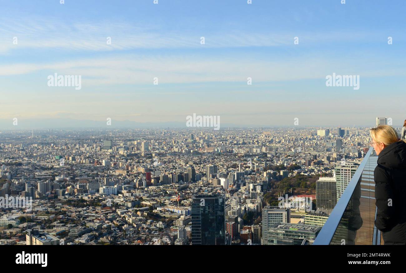 Tourist enjoying the views from the Shibuya Sky rooftop observation ...
