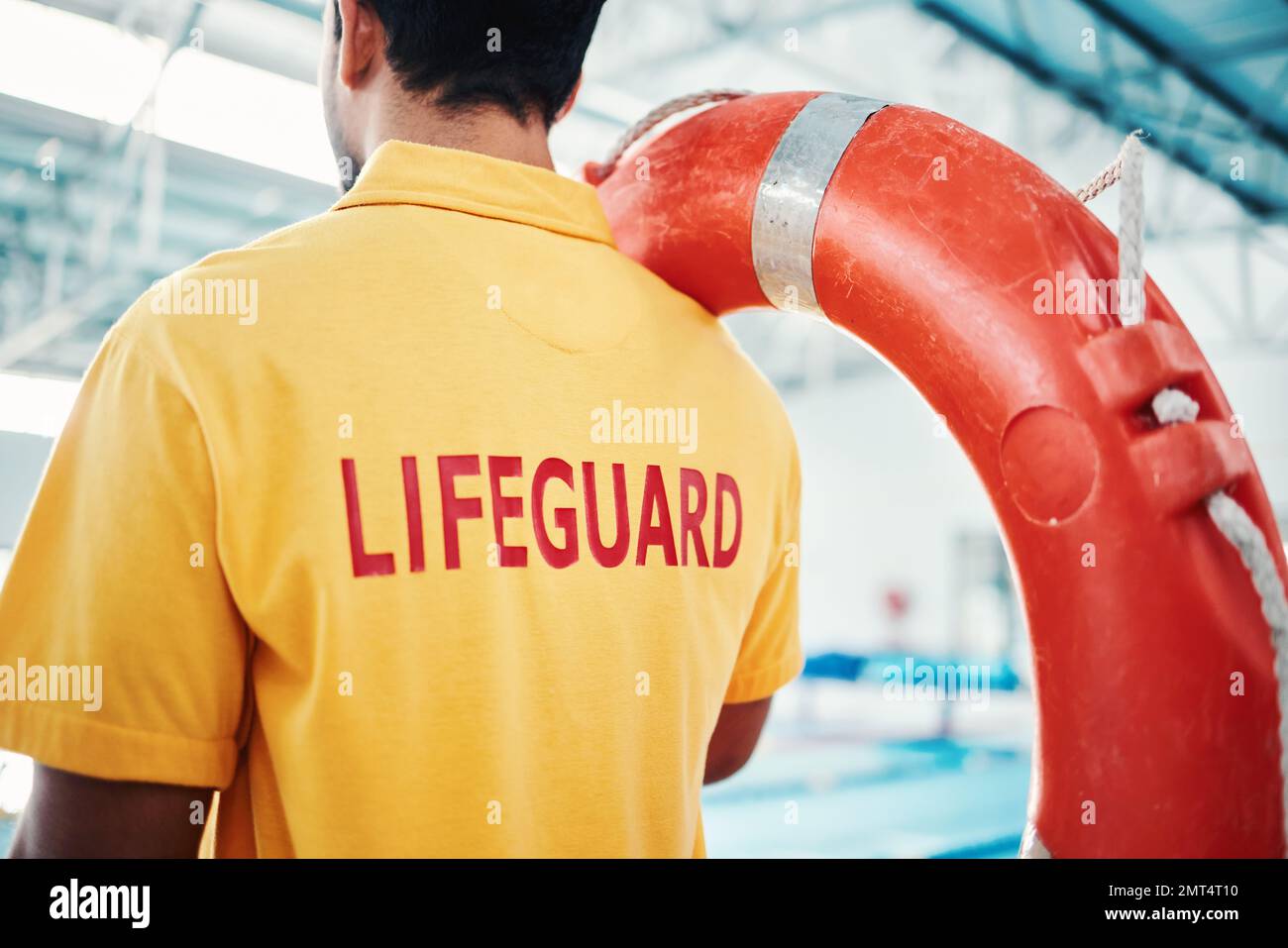 Lifeguard, man and swimming pool safety at indoor facility for training ...