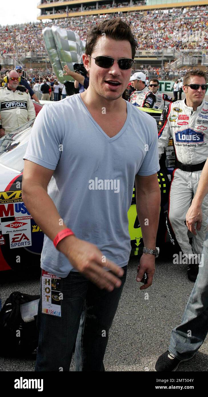 Singer Nick Lachey waits by NASCAR driver Jimmie Johnson's car prior to ...