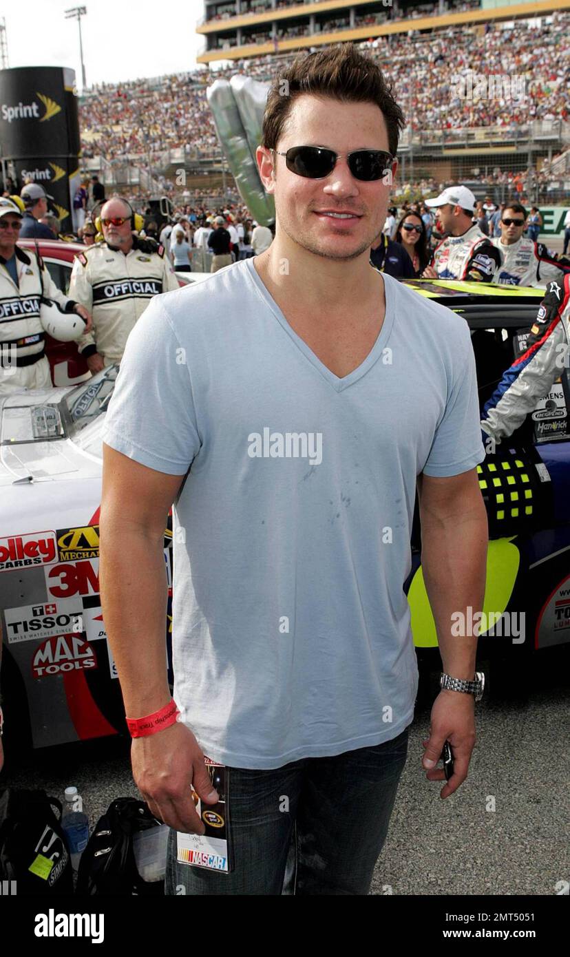 Singer Nick Lachey waits by NASCAR driver Jimmie Johnson's car prior to ...